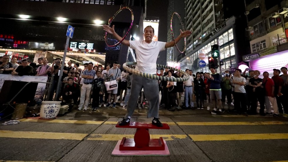 The surprising life story of Hong Kong street acrobat, 67, who dives ...