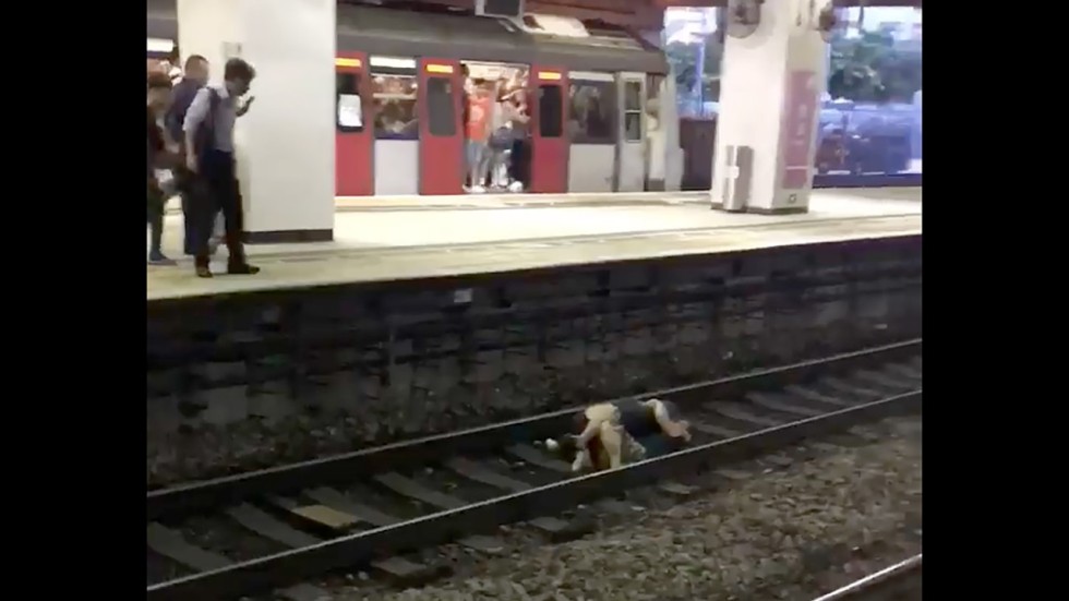 Two men get in a fight at Hong Kong MTR station, fall on track | South ...
